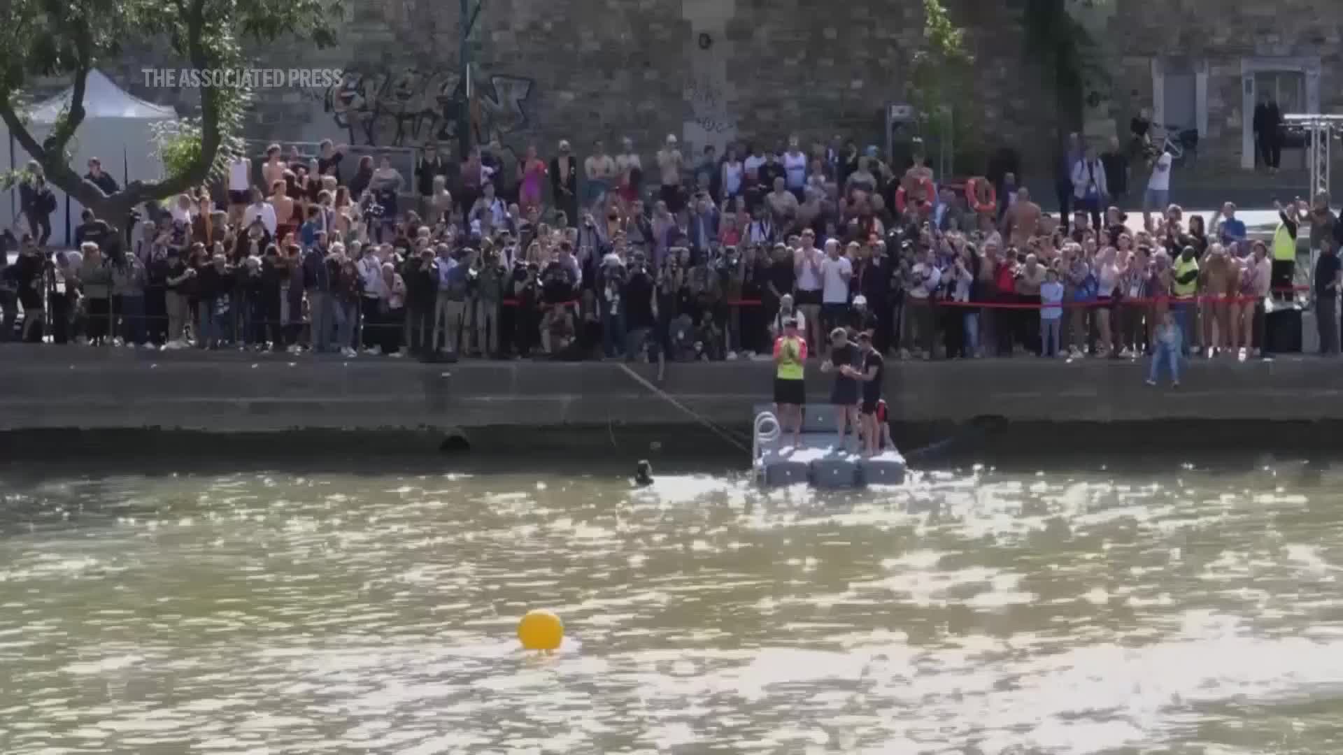 Paris mayor dips into the Seine River to showcase its improved ...